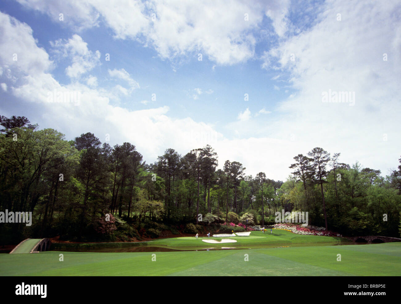Long view of golf course green over stream Stock Photo - Alamy