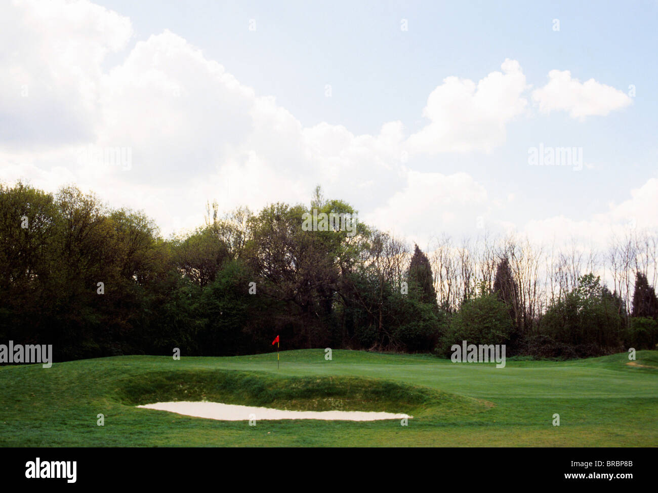 Golf course green seen across a deep sand bunker Stock Photo - Alamy