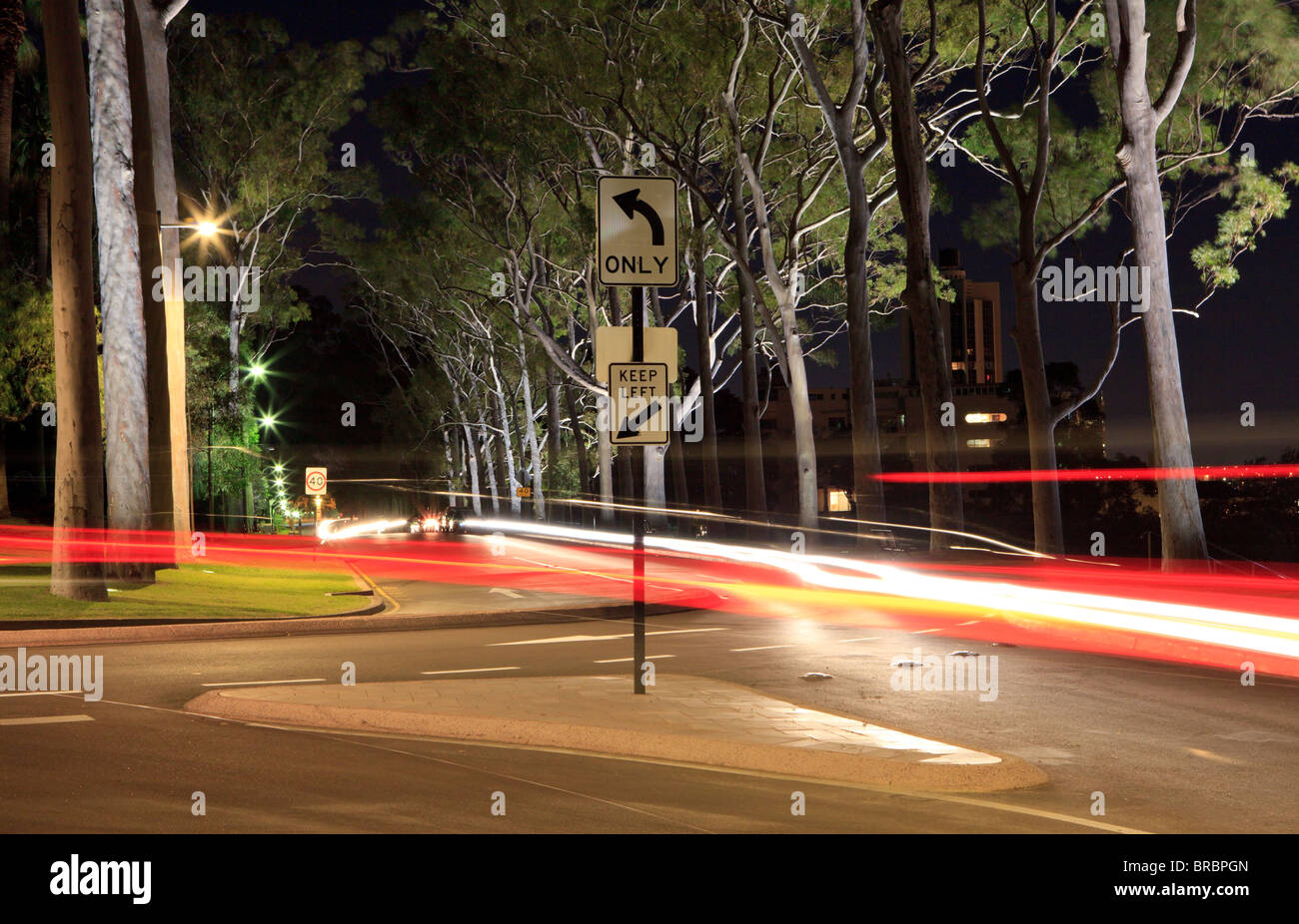 Keep left and left turn only sign in the middle of a busy street at ...