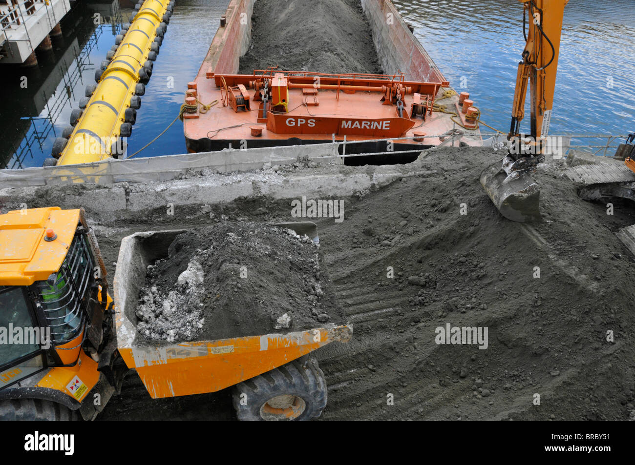 Construction site dumper truck tipping earth from foundation dig into ...