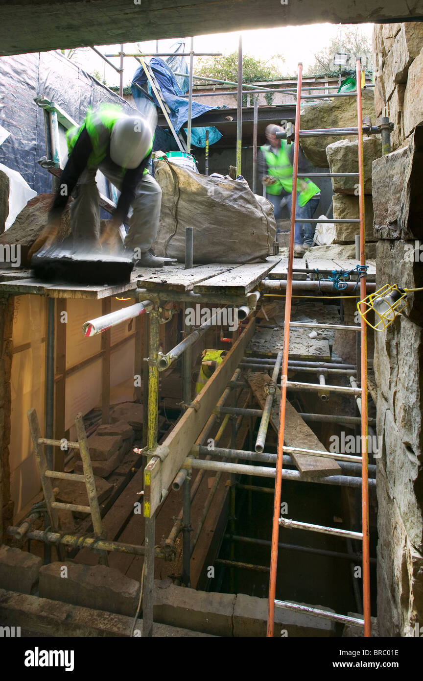 Worker on scaffold tower lifting materials Stock Photo - Alamy