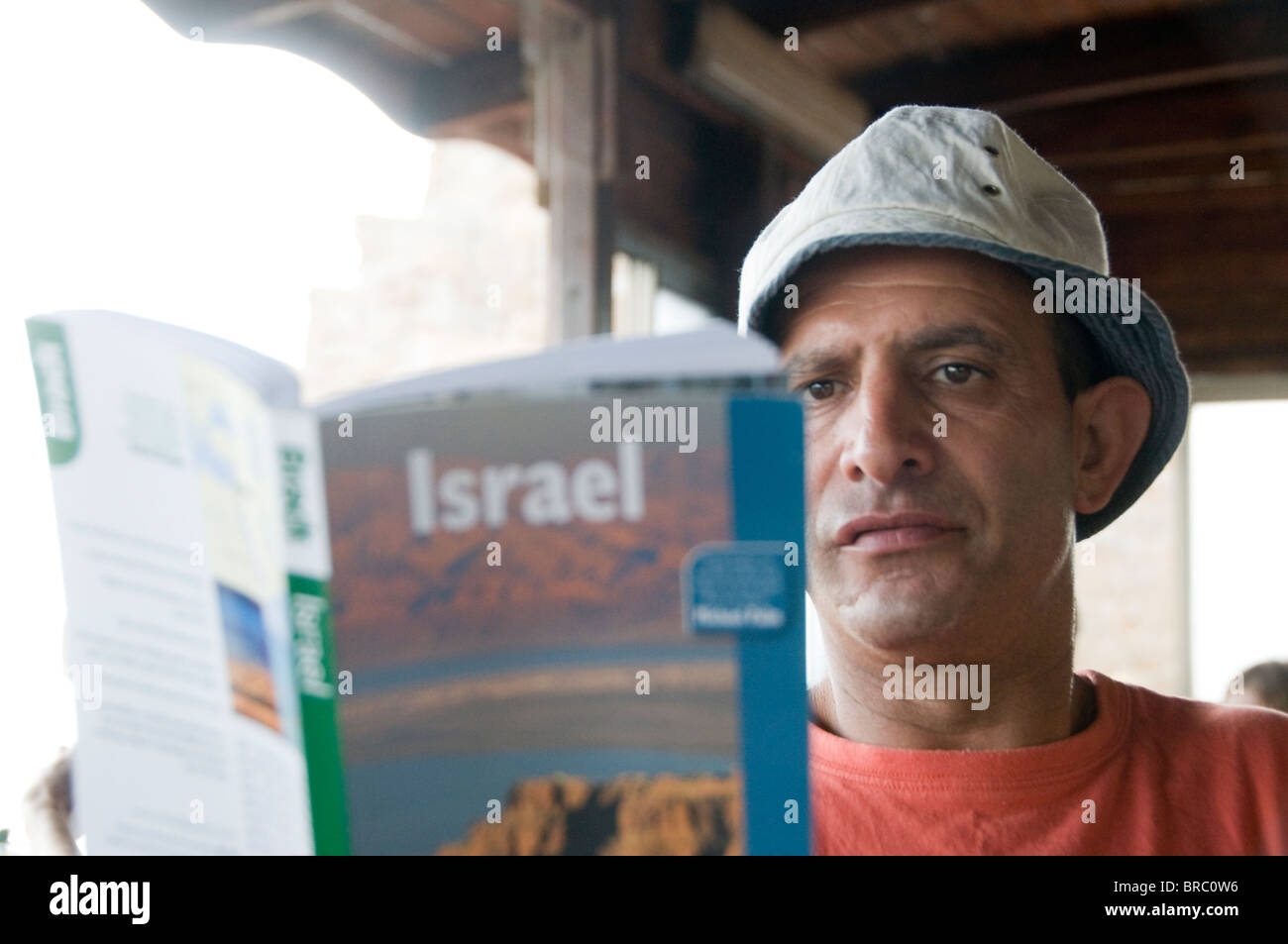 Man reading an Israeli guide book Stock Photo - Alamy