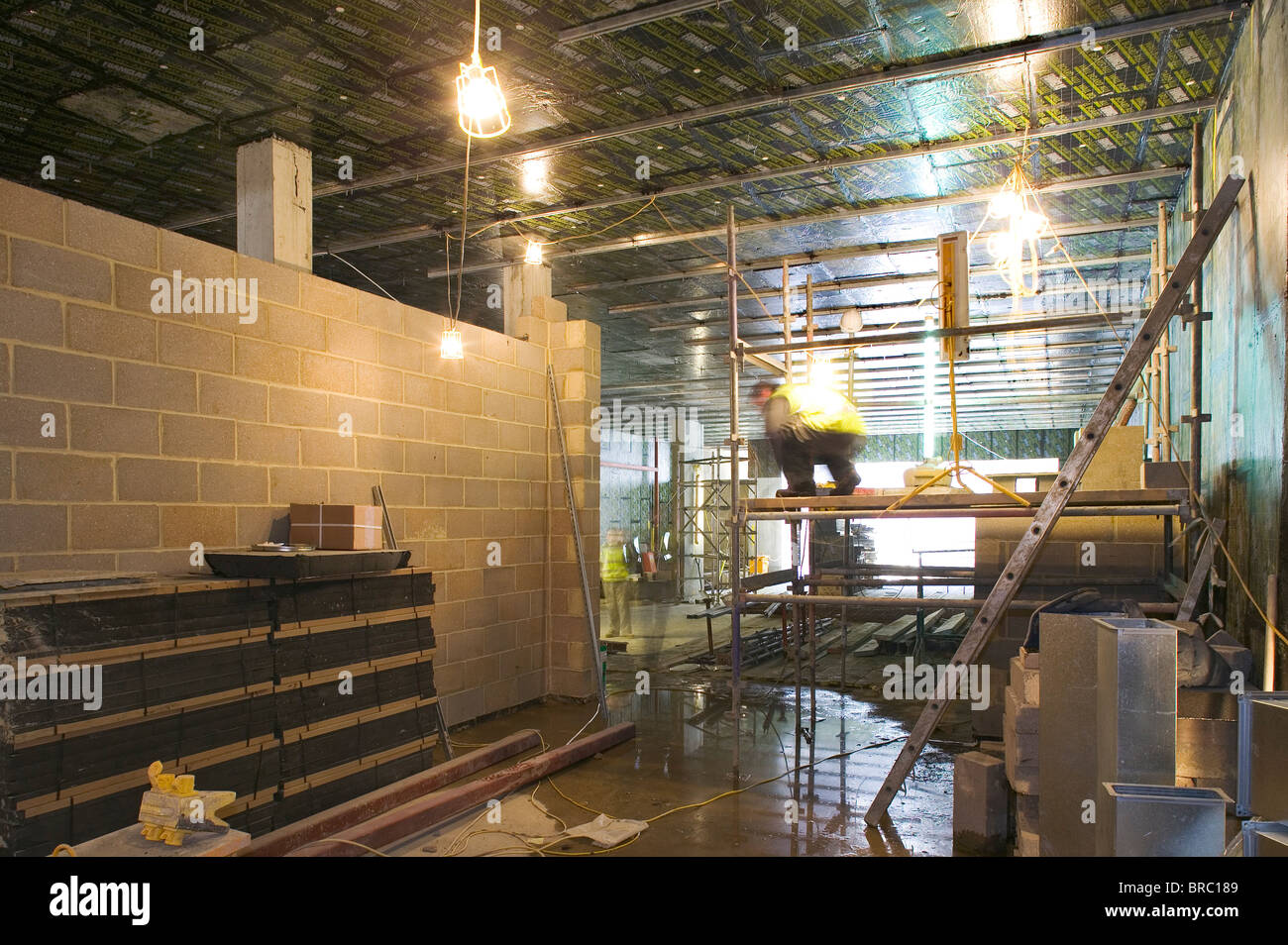 Interior space in construction with worker Stock Photo - Alamy