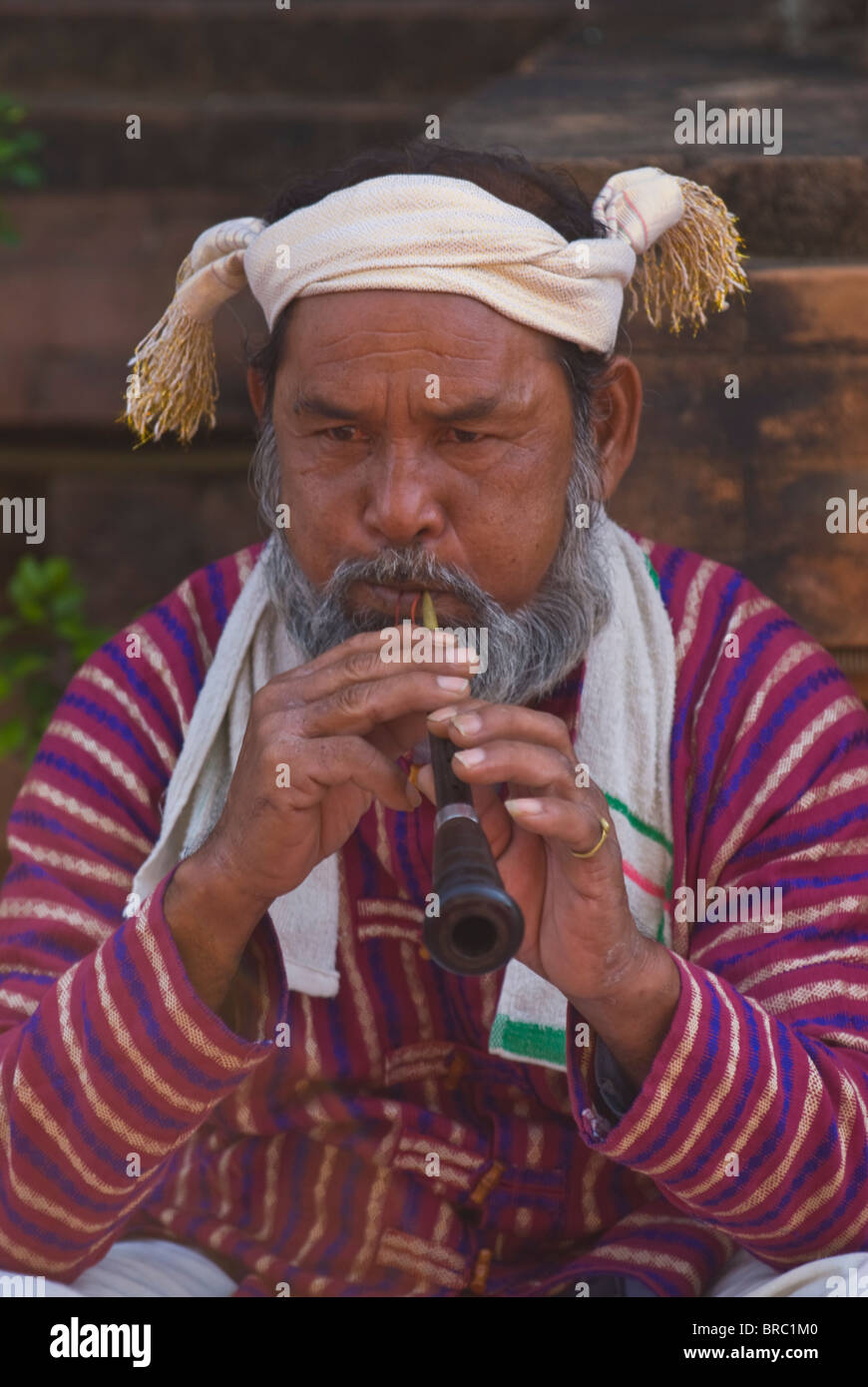 Traditionally dressed man blowing a pipe, Nha Trang, Vietnam, Indochina ...