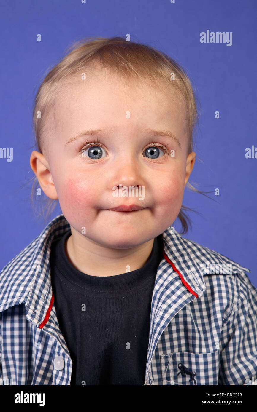 Baby boy biting lip hi-res stock photography and images - Alamy