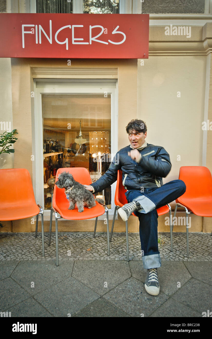 Owner outside 70's furniture store Stock Photo - Alamy