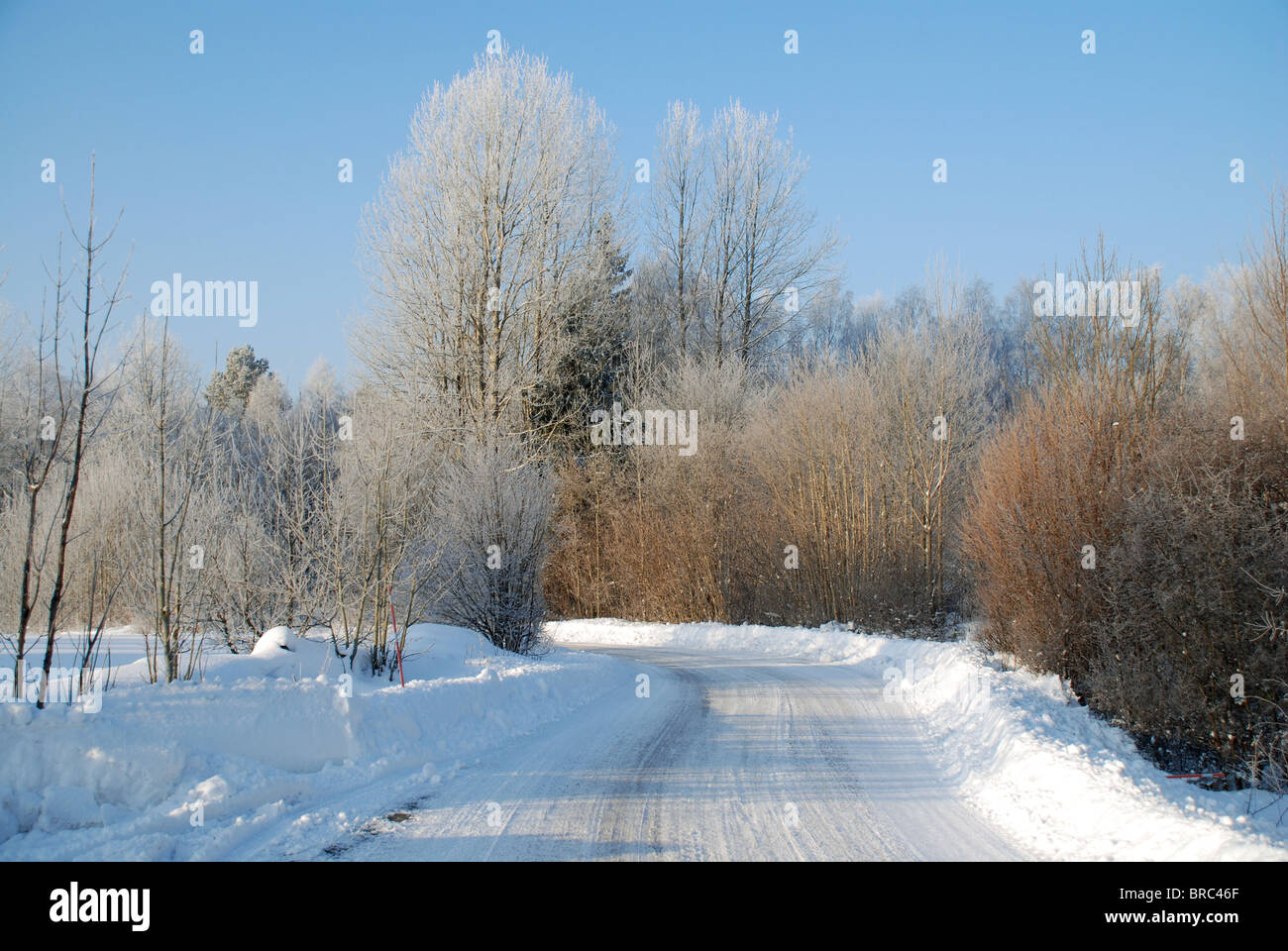 Small road in winter landscape Stock Photo - Alamy