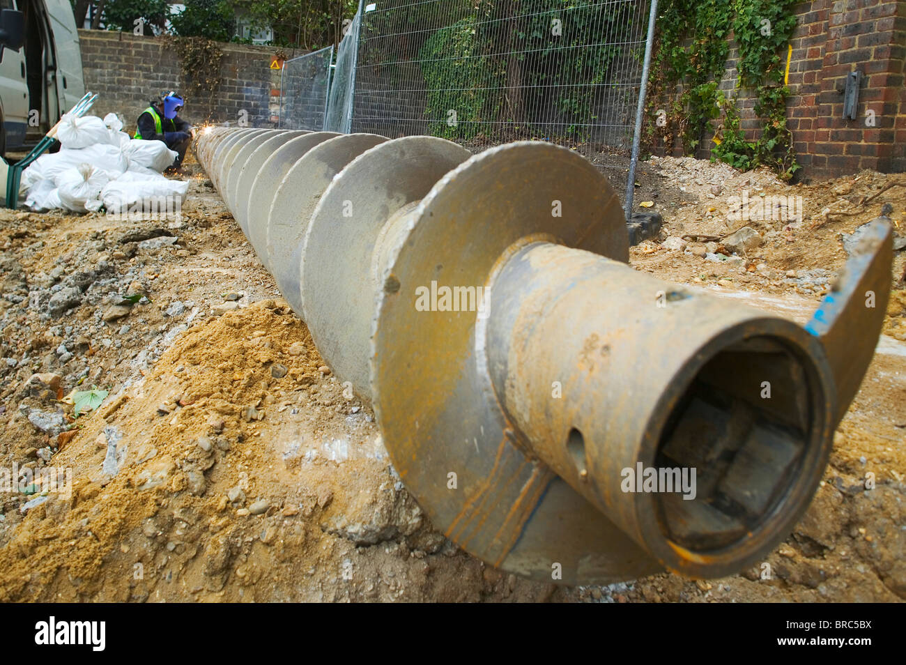 Piling drill on building site with welder at work Stock Photo - Alamy
