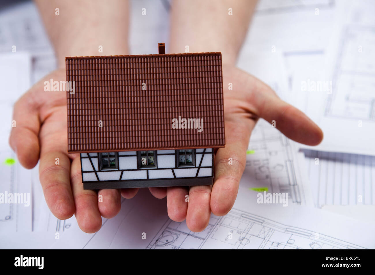 The house in human hands Stock Photo - Alamy