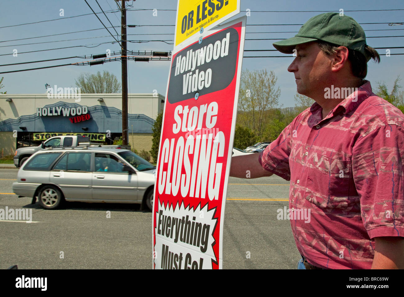 Man holds sign for Hollywood Video Store Closing Going Out of Business ...
