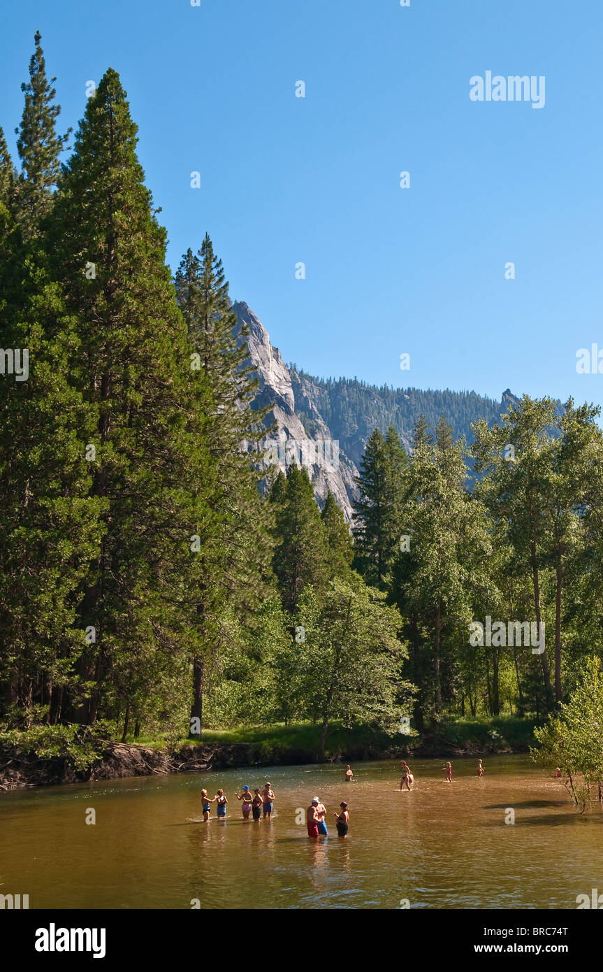 Tourists swim in the Merced River, Yosemite National Park, California ...