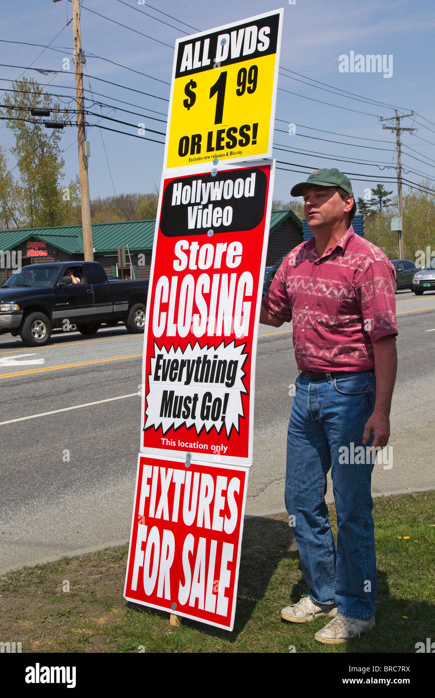 Man holds sign for Hollywood Video Store Closing Going Out of Business ...