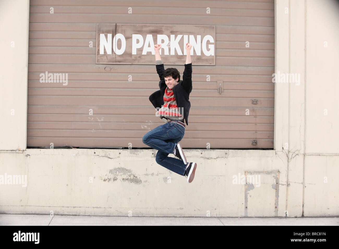 Young Man Having Fun By A Loading Dock; Portland, Oregon, United States ...