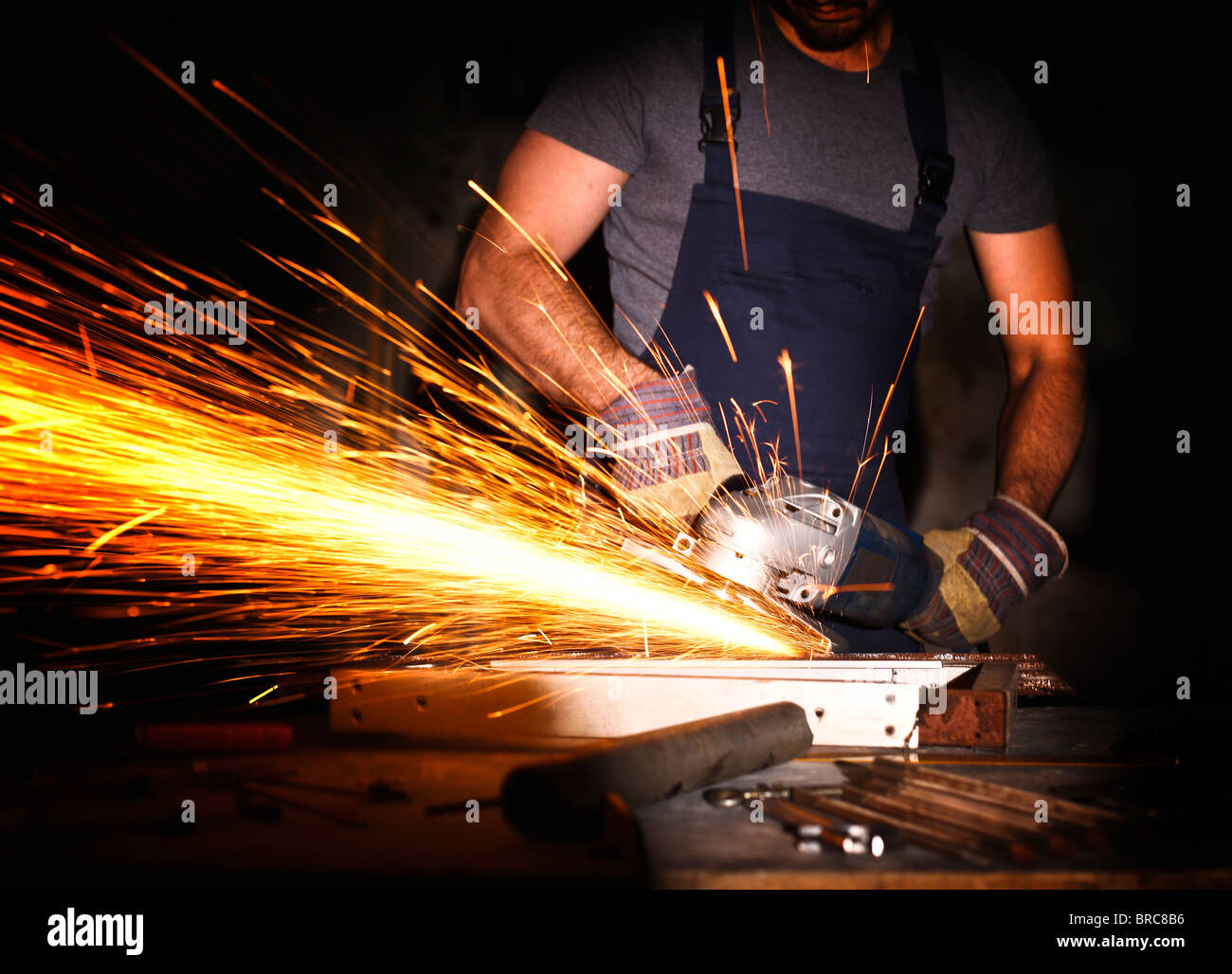 handyman work in factory with electric grinder Stock Photo - Alamy