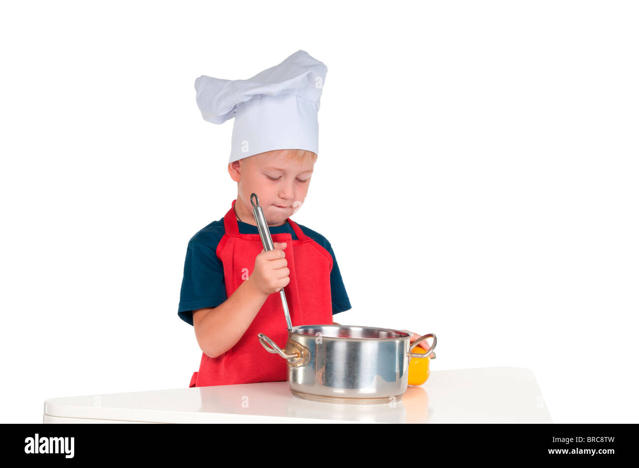 Young boy in a chef costume preparing food Stock Photo - Alamy