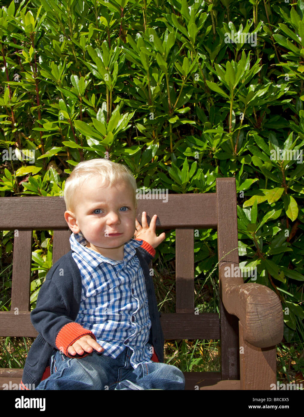 Boy sat on bench hi-res stock photography and images - Alamy