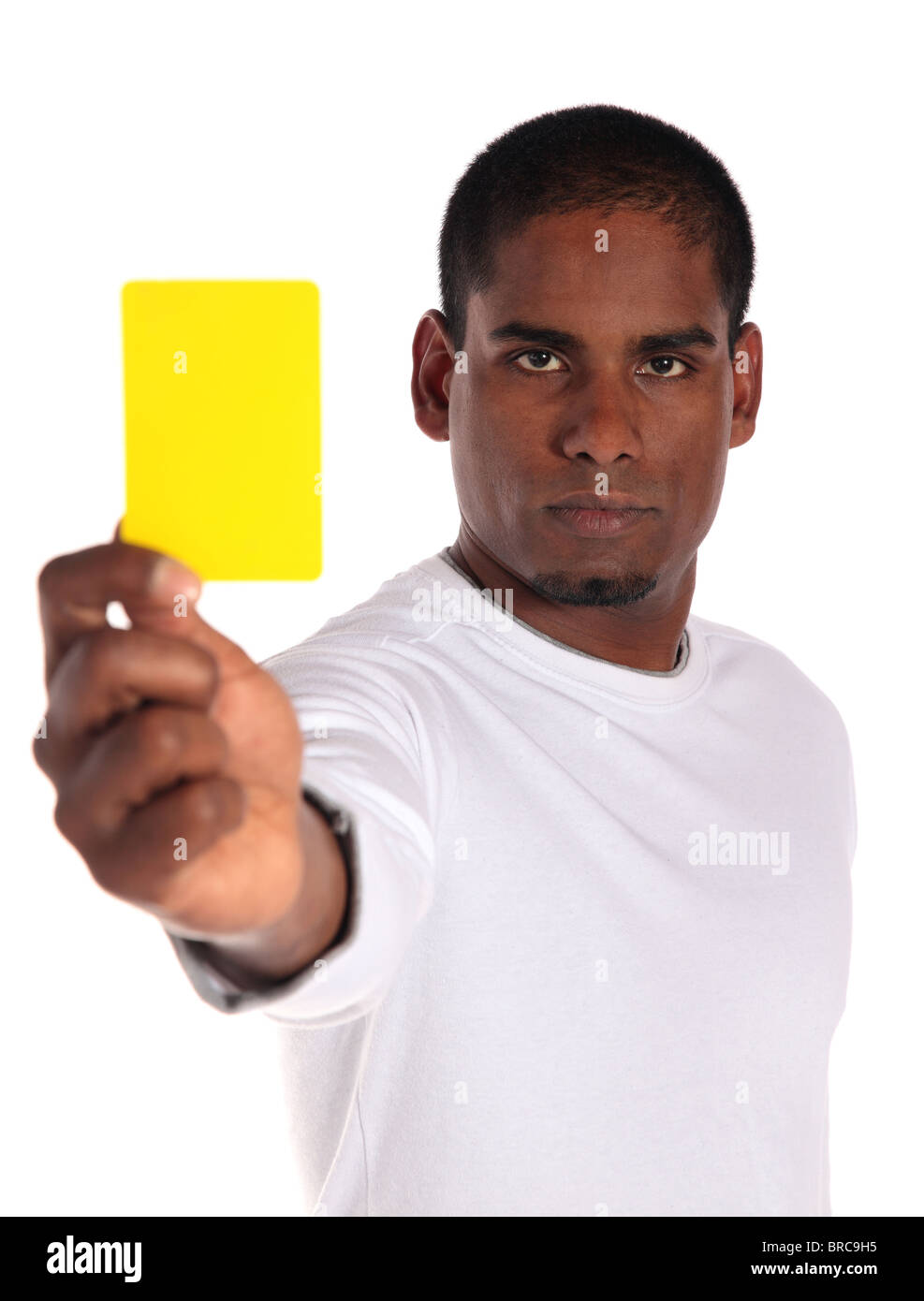 An attractive dark-skinned man showing a yellow card. All on white ...