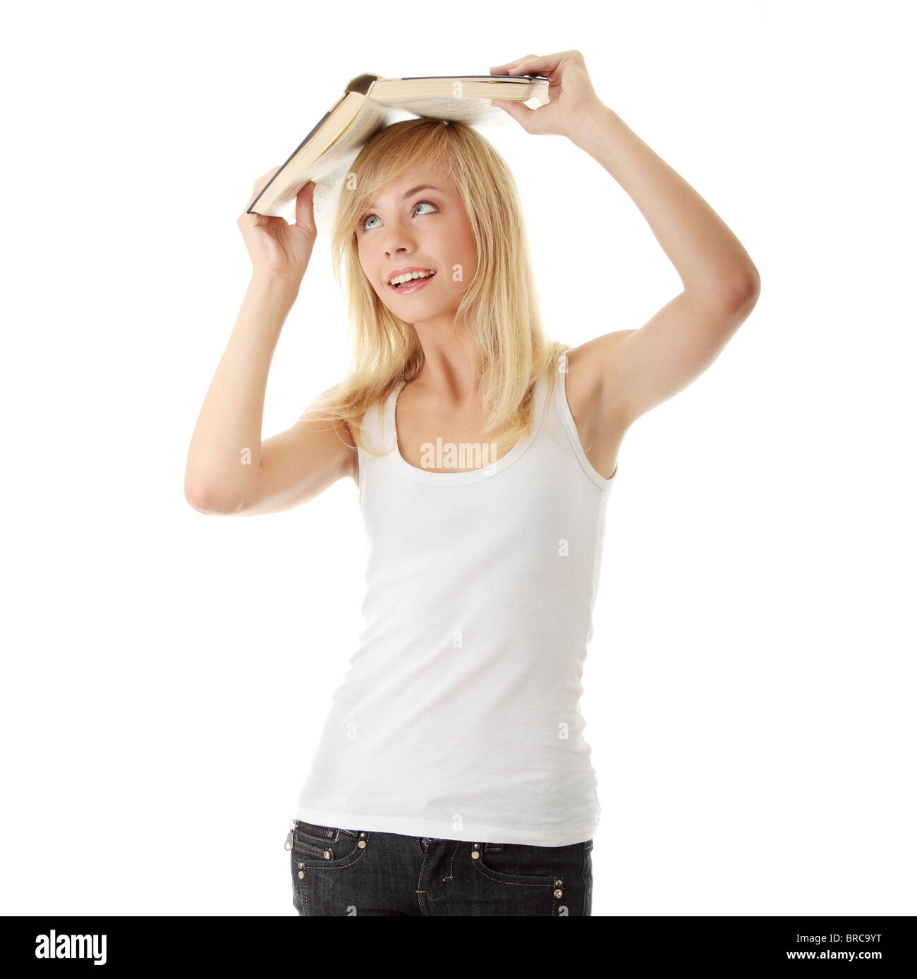 Teen girl with book over her head, isolated on white Stock Photo - Alamy
