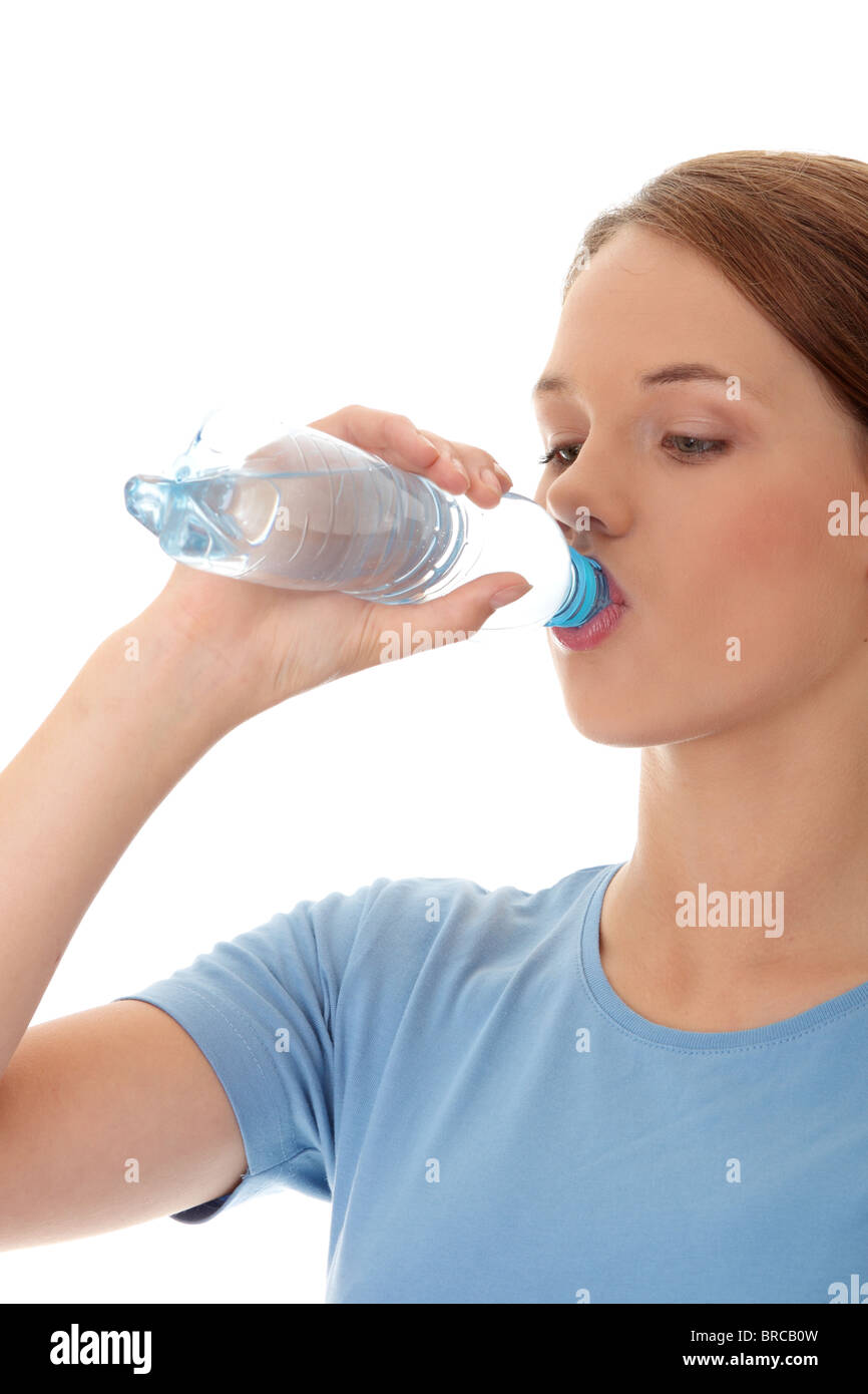 Teen woman drinking water isolated on white background Stock Photo - Alamy