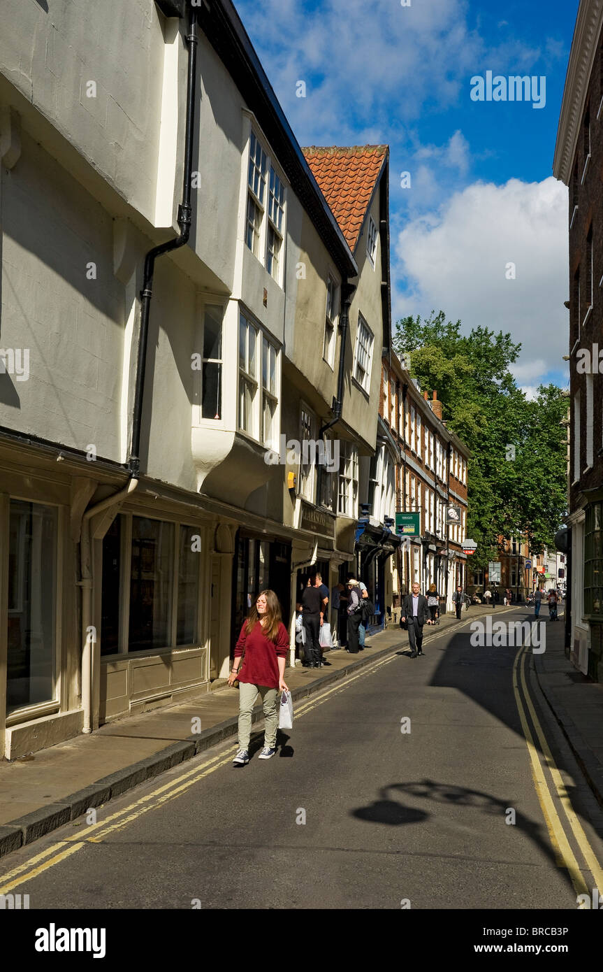 People tourists visitors walking along High Petergate in summer in the ...