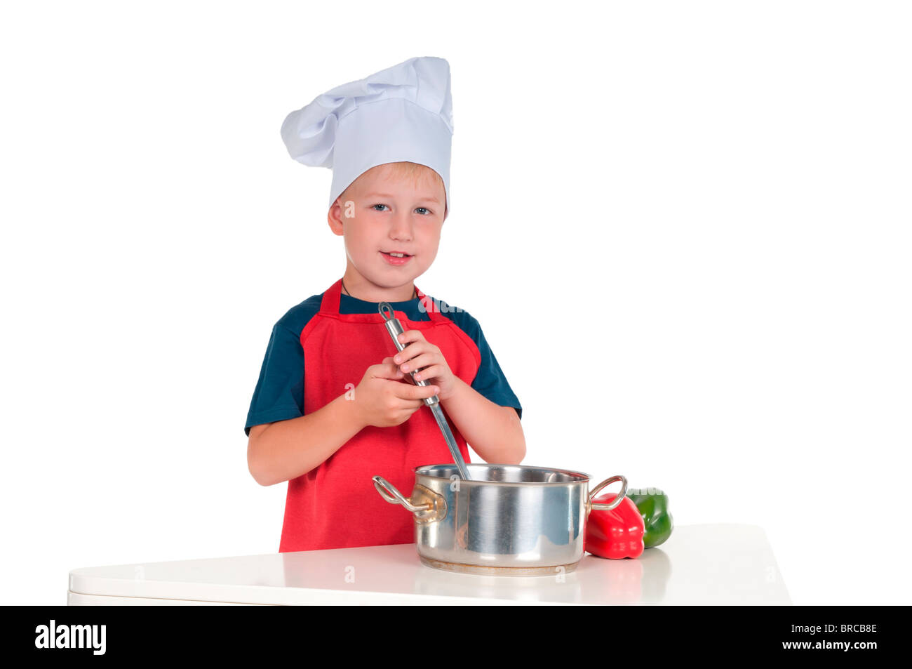 Little boy dressed like a chef making diner Stock Photo - Alamy