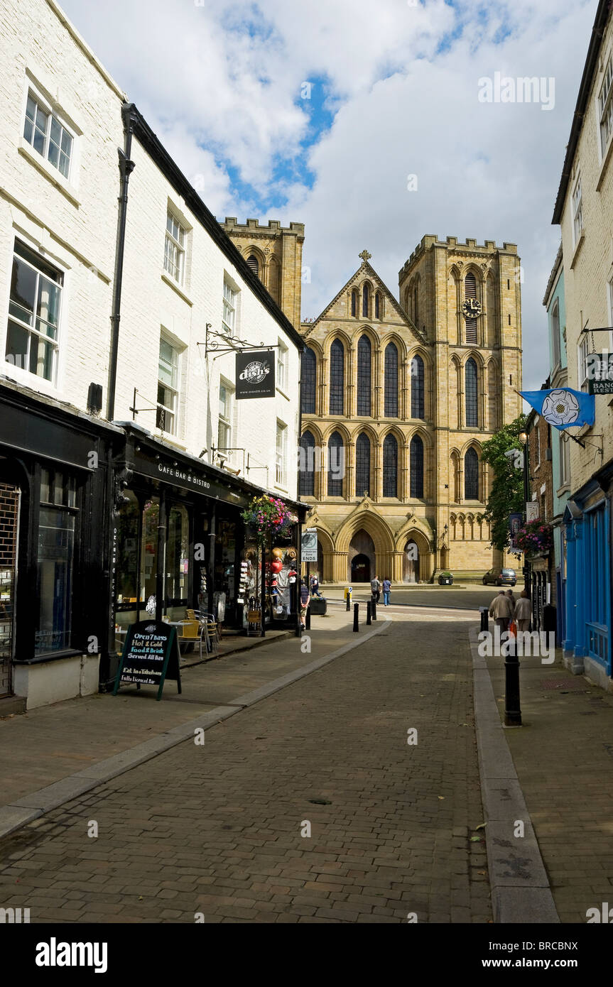 Shops stores and West Front of Ripon Cathedral from Kirkgate in summer ...