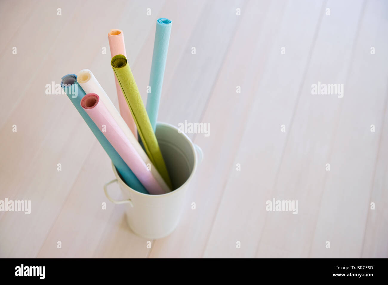 Rolled wrapping paper in a pitcher Stock Photo - Alamy