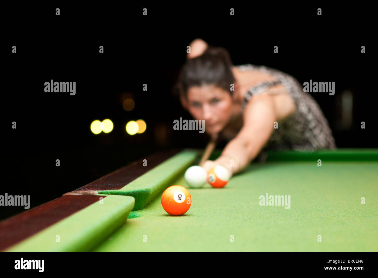 Young woman playing pool Stock Photo - Alamy