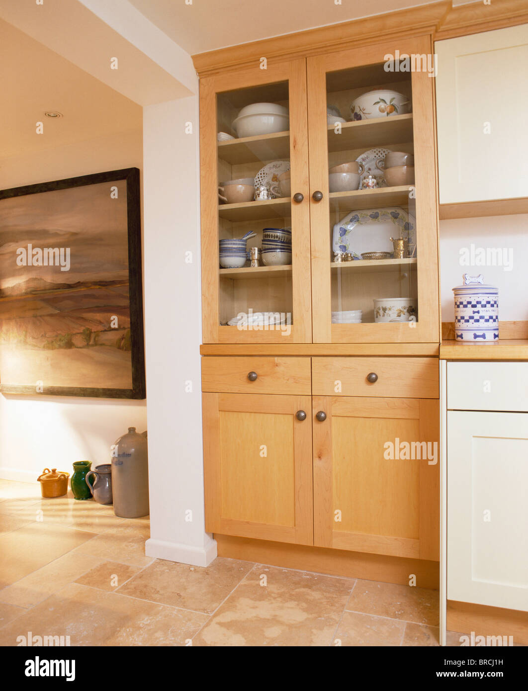 Pale wood fitted dresser with glazed doors in country kitchen Stock ...