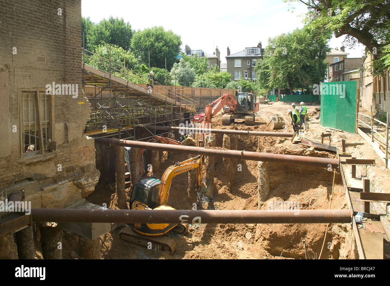 Digger in action on building site Stock Photo - Alamy