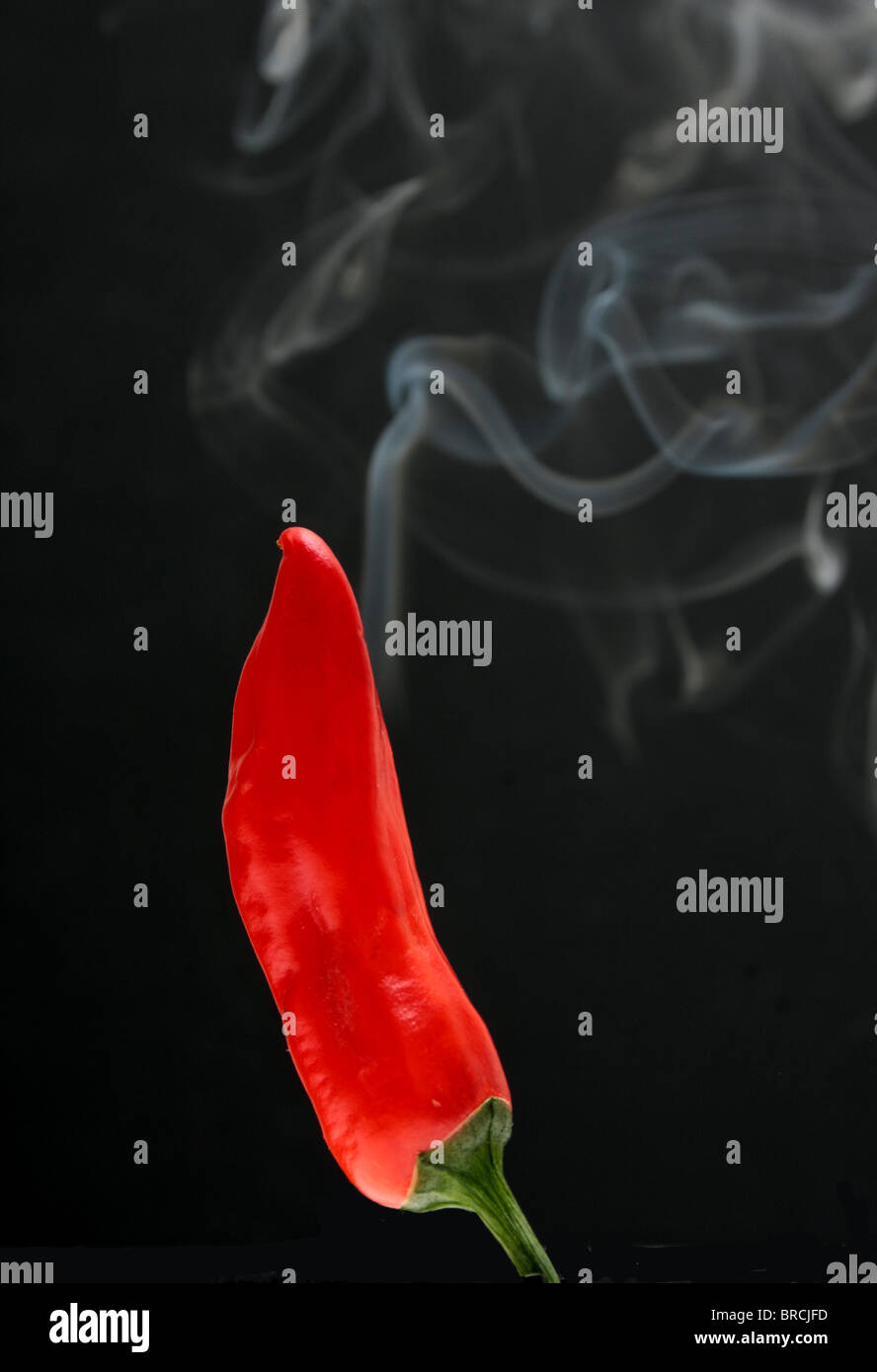 single red chili pepper with smoke coming from it Stock Photo - Alamy
