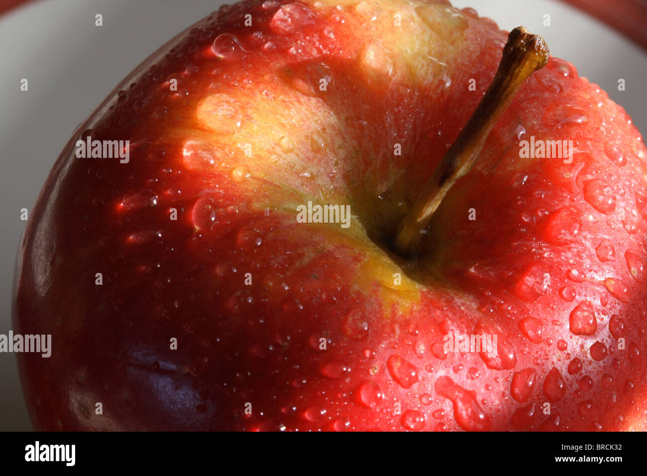 Red Ripe Apple Covered in Water Drops Stock Photo - Alamy