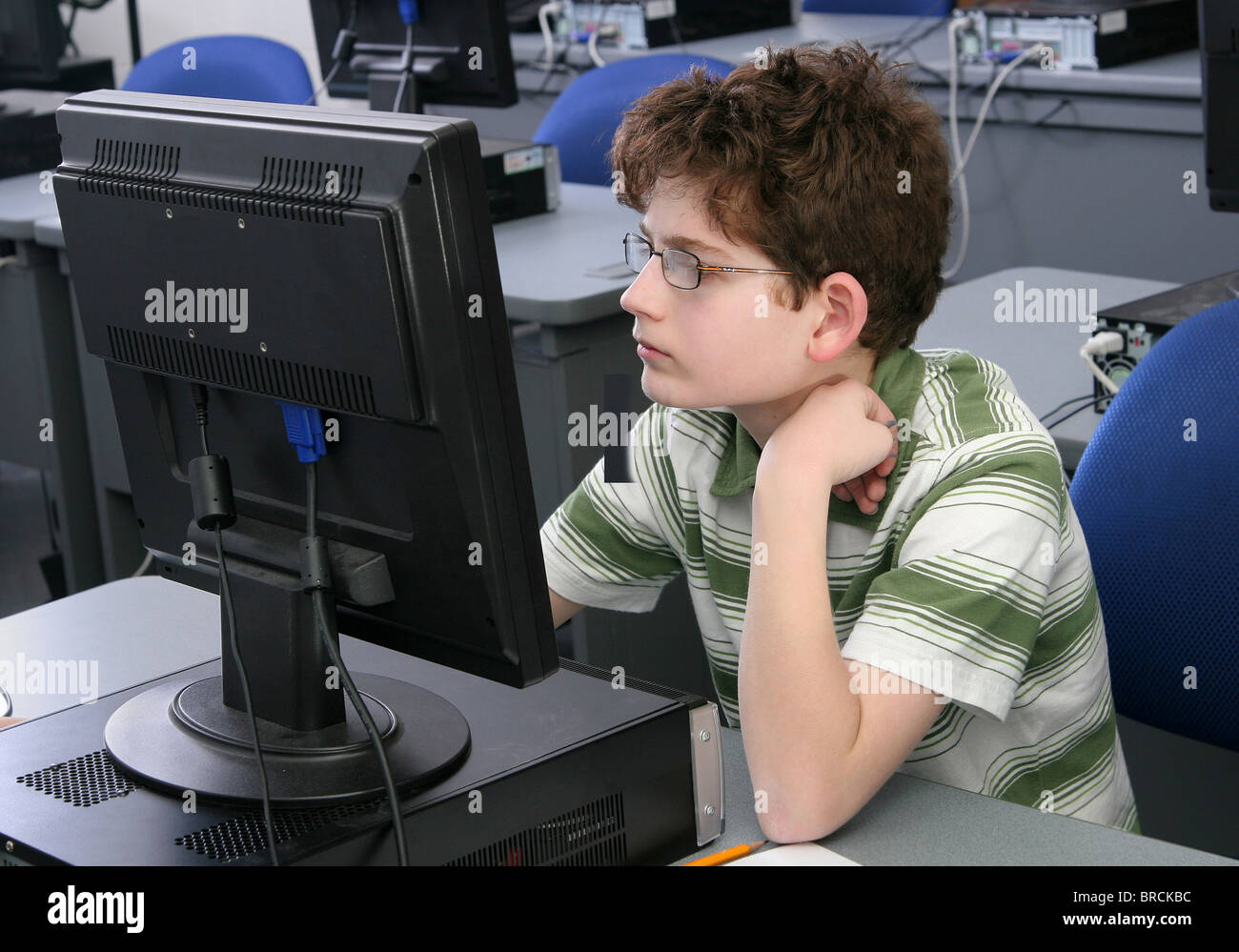 one young student boy studying on the computer in school Stock Photo ...