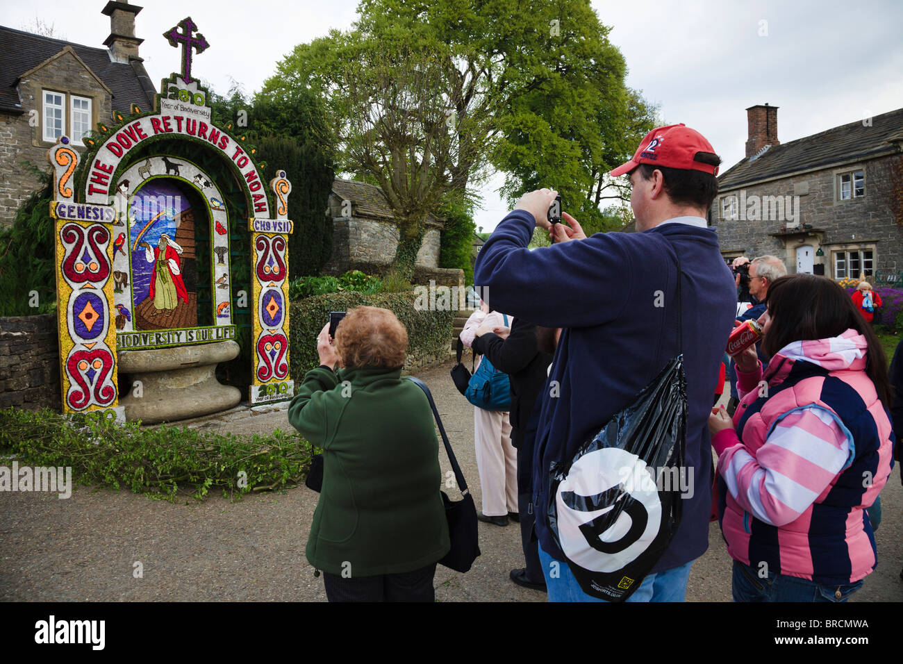 Visitors taking photos of well dressing at Tissington, Peak District ...