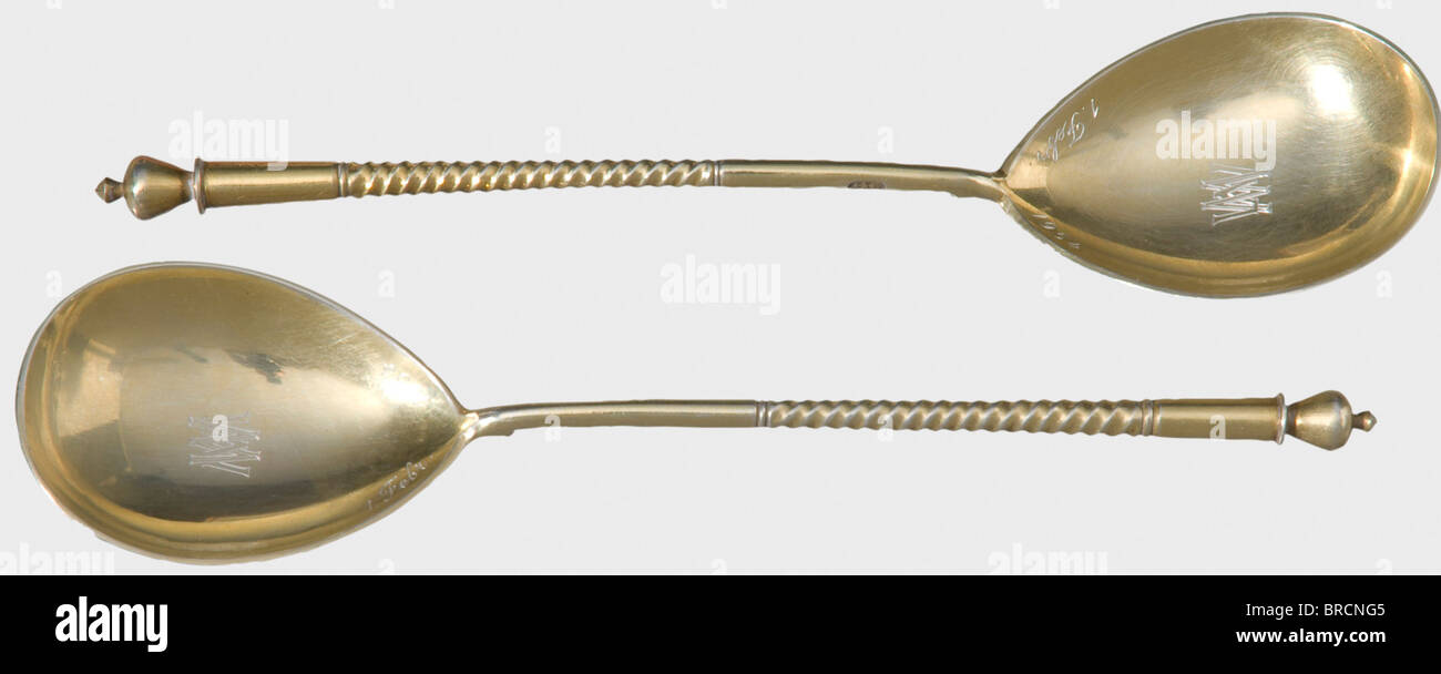 A pair of vermeil spoons, baptism gift 1897 and 1954 Gilt silver, with ...