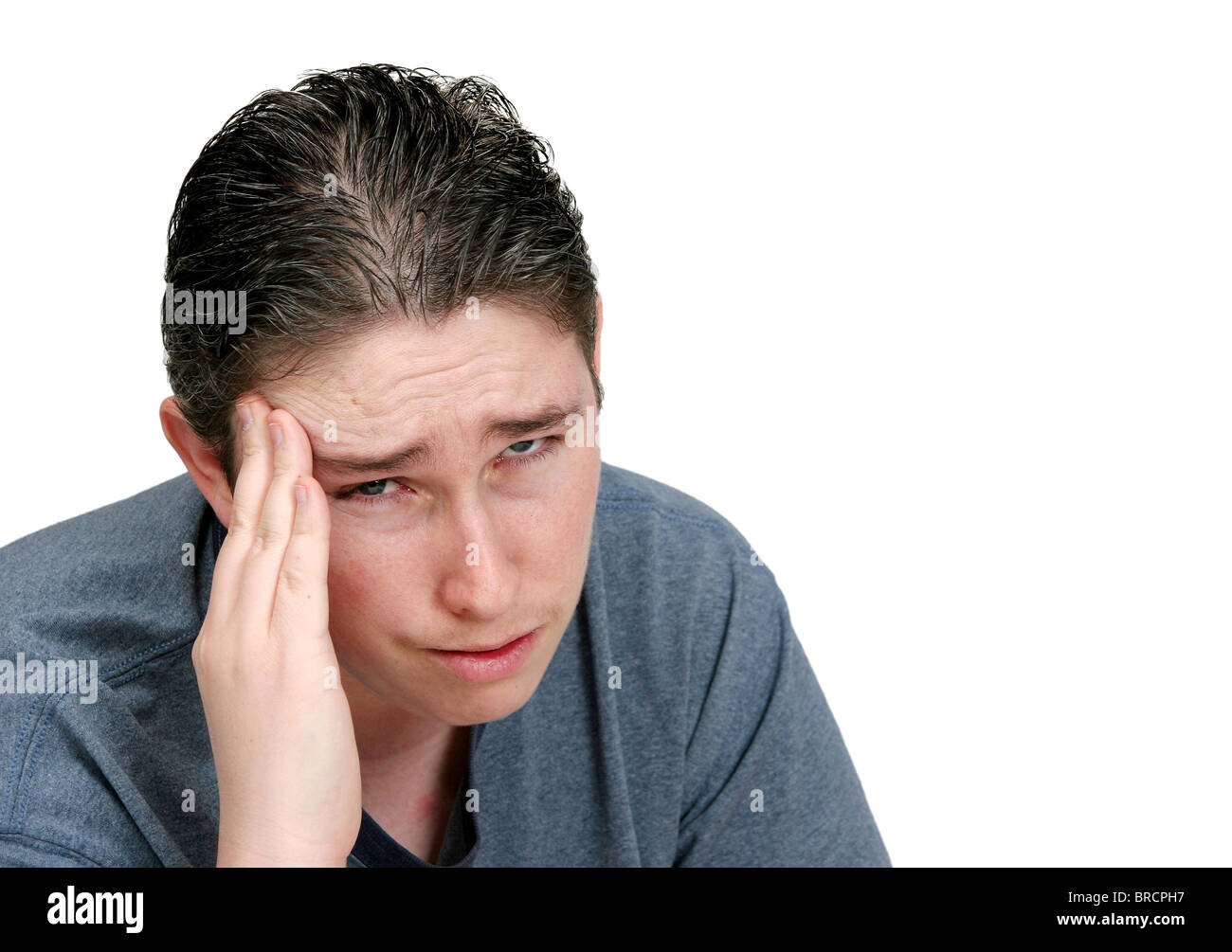 one adult man with a headache or head pain holding his head in worry or ...