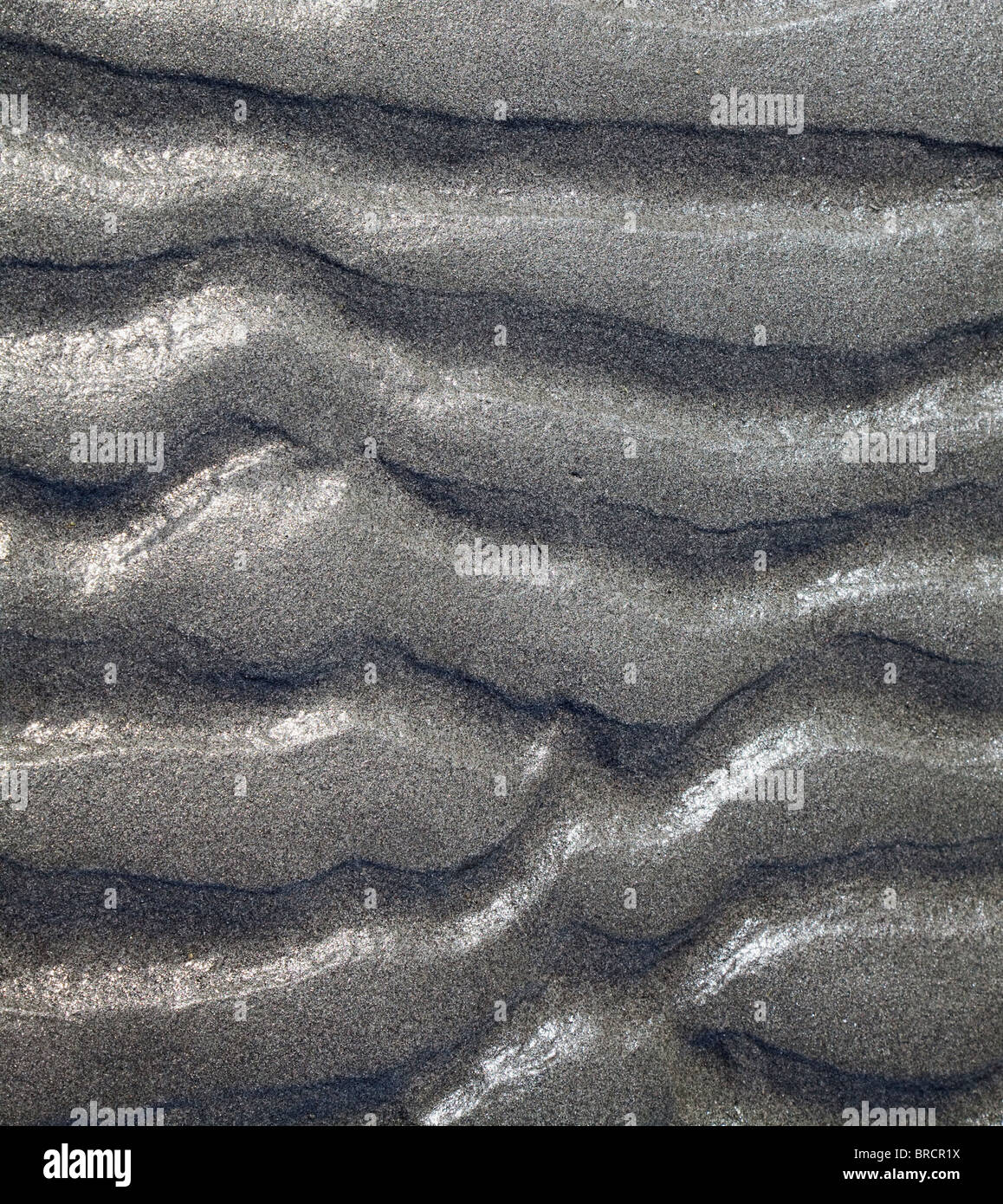 patterns created water flow in wet sand on beach Stock Photo - Alamy