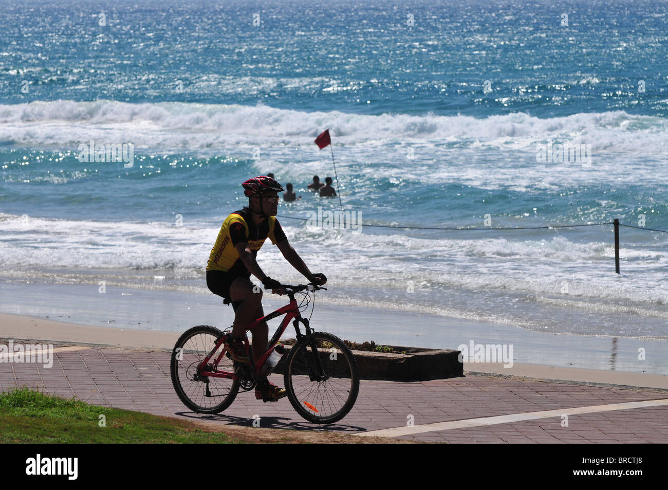Israel, Haifa, Dado Beach, Man rides bicycle on the beach Stock Photo ...
