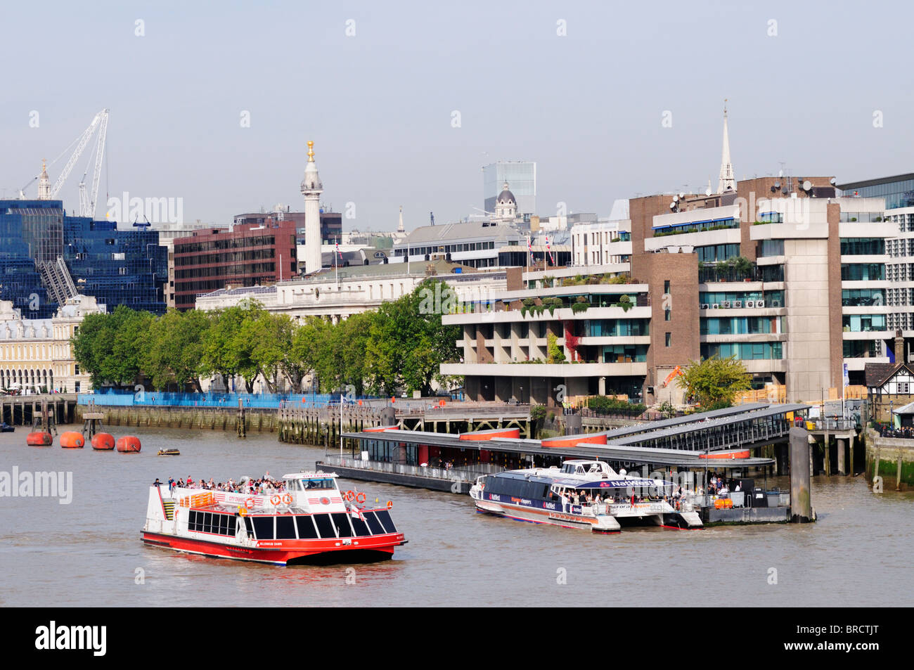 Thames Clippers Riverbus and City Cruises tour boat at Tower Pier ...