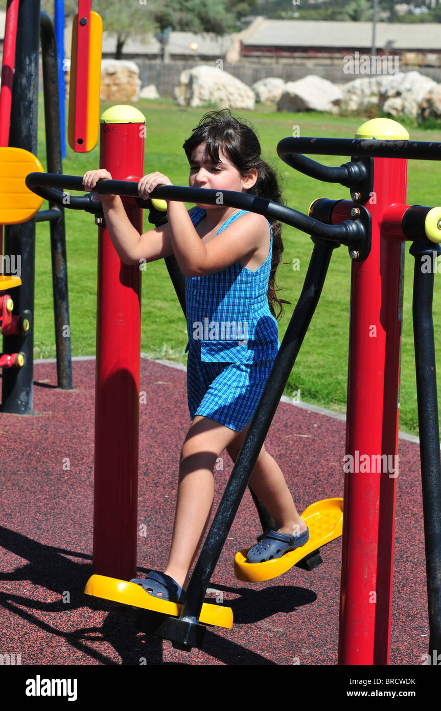 Israel, Haifa, Girl of 6 plays in a public fitness playground - model ...