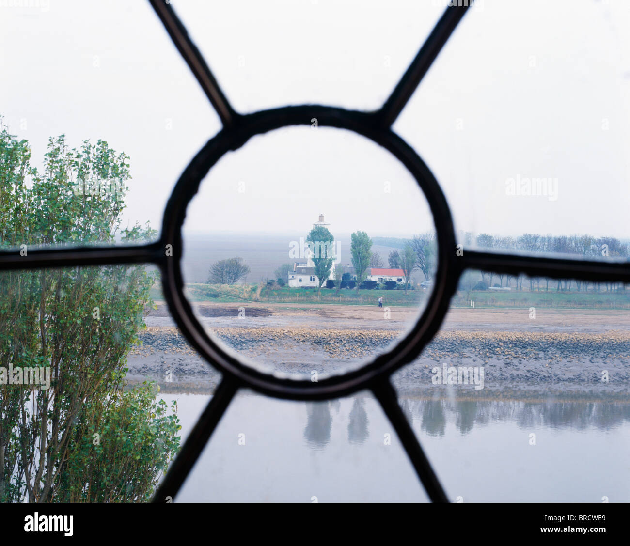 View of wide river through window with circular frame Stock Photo - Alamy