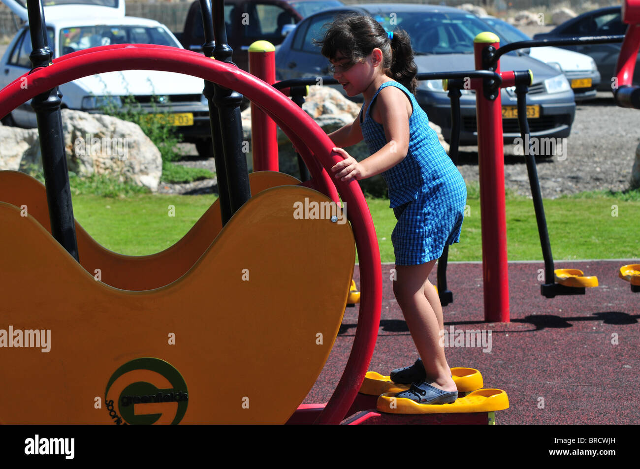 Israel, Haifa, Girl of 6 plays in a public fitness playground - model ...
