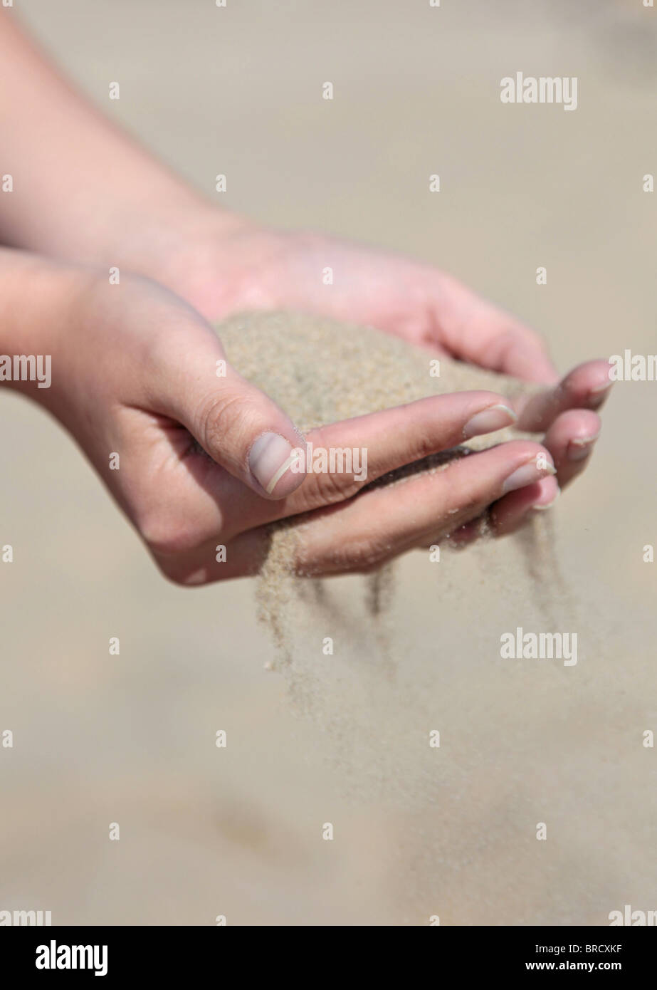 A person holding dry sand in his hands Stock Photo - Alamy