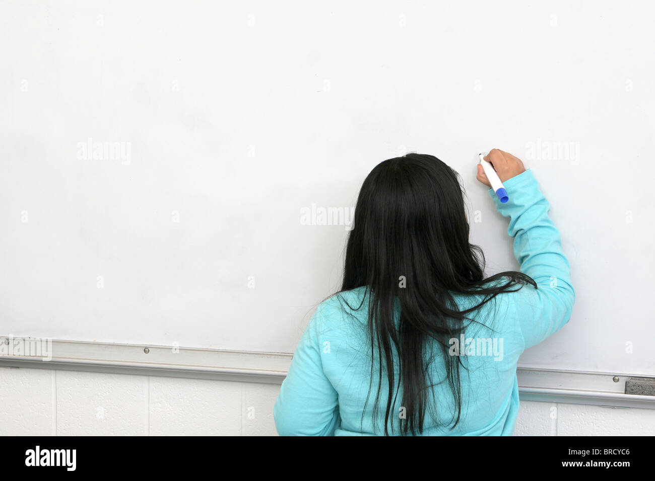 one young student writing on a blank whiteboard Stock Photo - Alamy