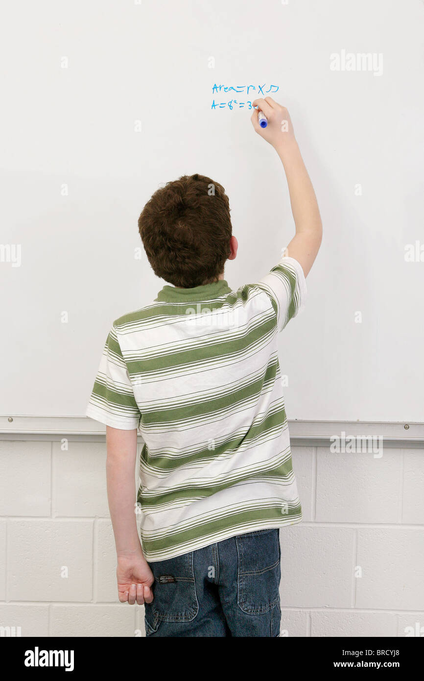 one young student writing on a blank whiteboard Stock Photo - Alamy