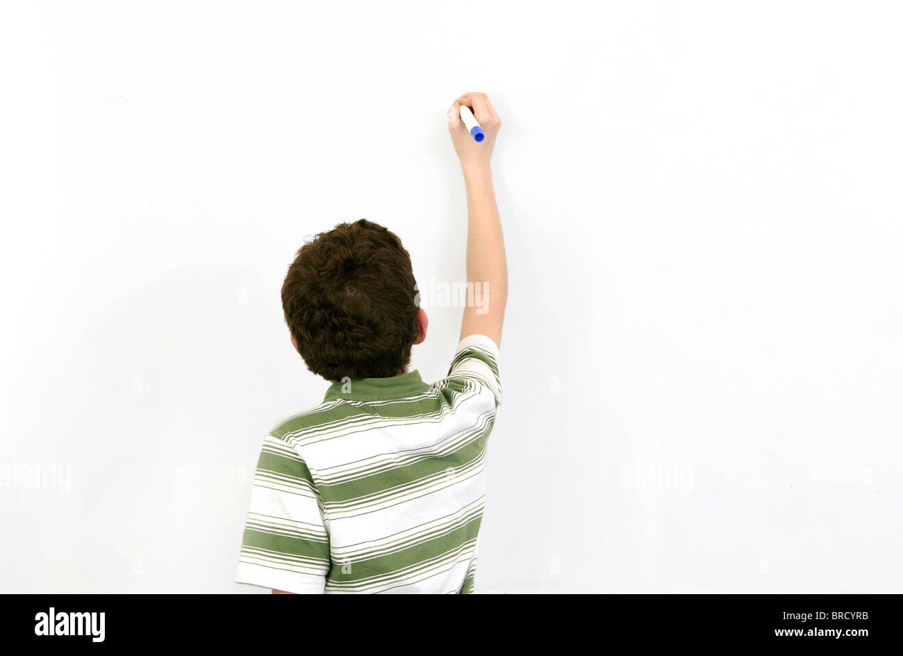 one young boy student writing on a blank whiteboard Stock Photo - Alamy