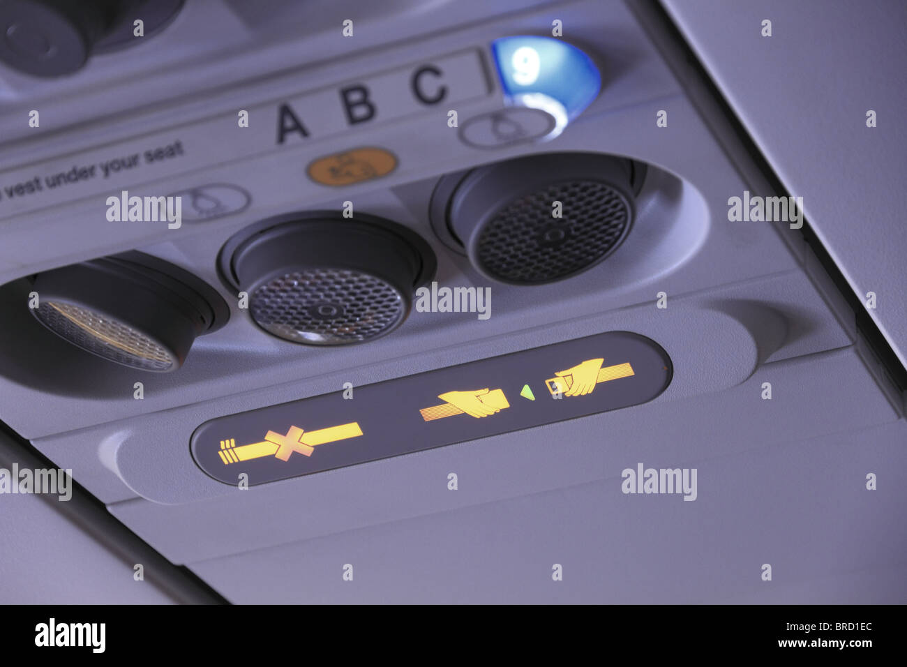 Overhead panel on a passenger jet aircraft with both the "fasten ...