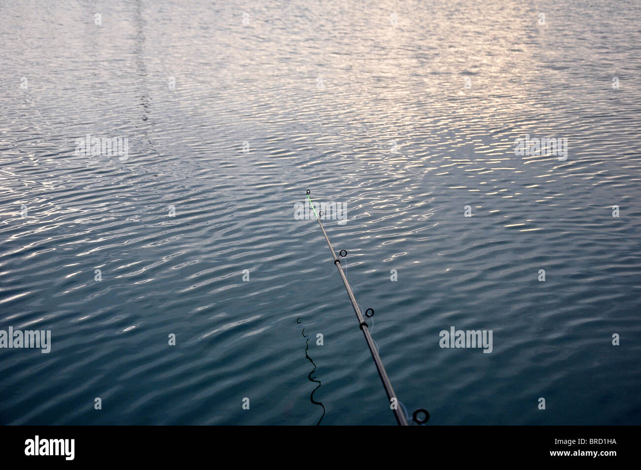 fishing rod over water Stock Photo - Alamy