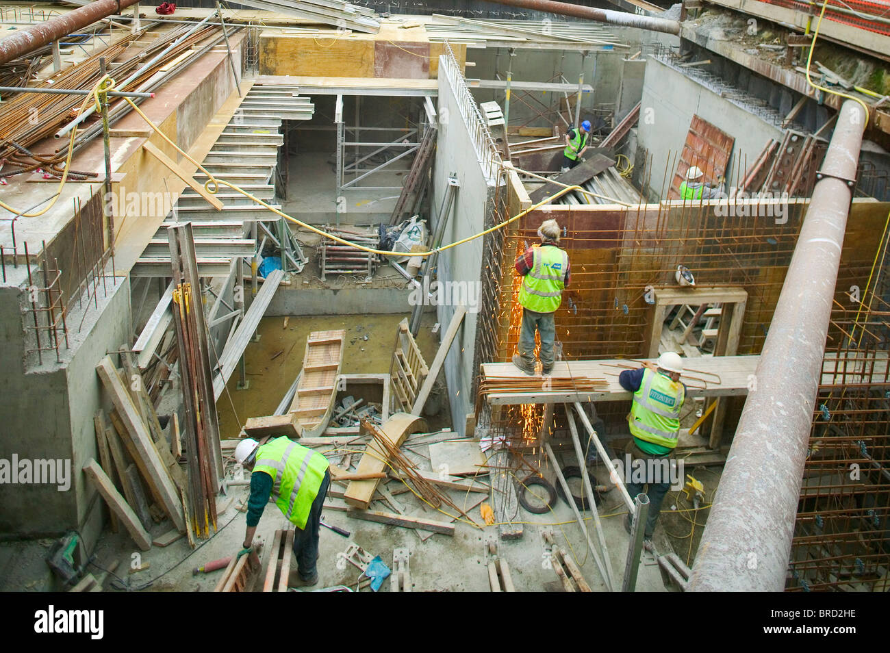 Workers in action on basement construction project Stock Photo - Alamy