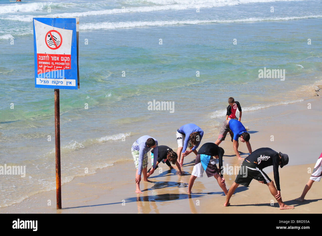 Israel, Haifa, summer activity on the beach Surfers workout on the ...